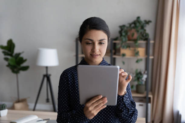Free Stock Photo of A young brunette woman looking at her tablet screen ...