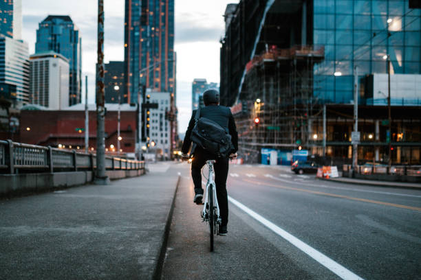 Free Stock Photo of Man Riding Bike Down Urban Street | Download Free ...