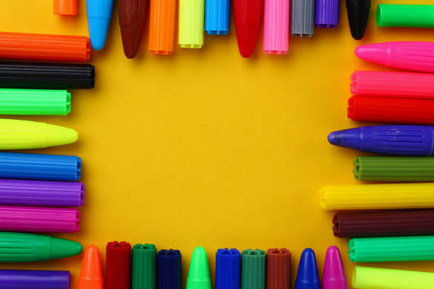 Free Stock Photo of A group of markers on a yellow and green background ...