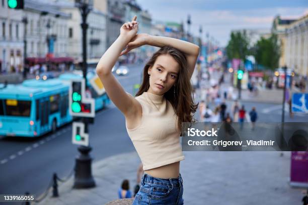 Slender 18 Year Woman On Crowded City Street Of Summer Evening Stock