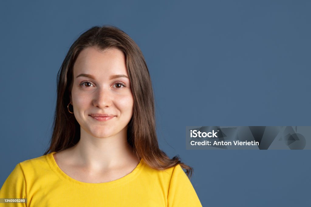 Closeup Portrait Of Young Beautiful Girl Wearing Yellow Shirt Isolated