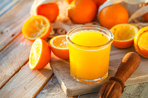 Glass Of Freshly Sqeezed Orange Juice On A Wooden Table Natural Source