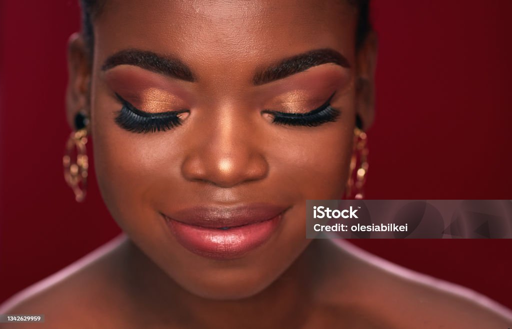 Portrait Of Beautiful Smiling African American Woman On Red Background