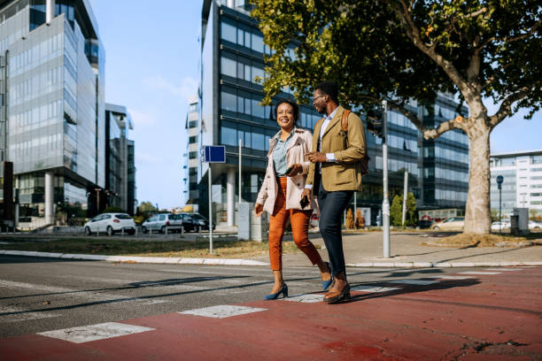 Free Stock Photo of Two People Crossing a Street in Front of a Building ...