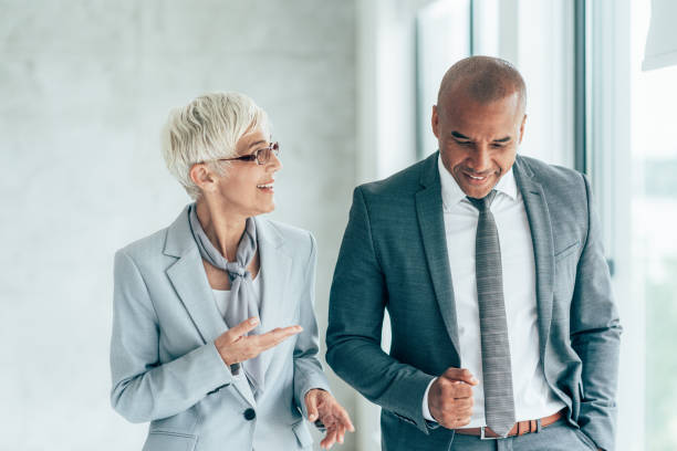 Free Stock Photo of Two business people conversing while taking a walk ...