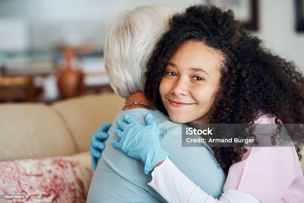 Cropped Portrait Of An Attractive Young Female Nurse Hugging Her Senior
