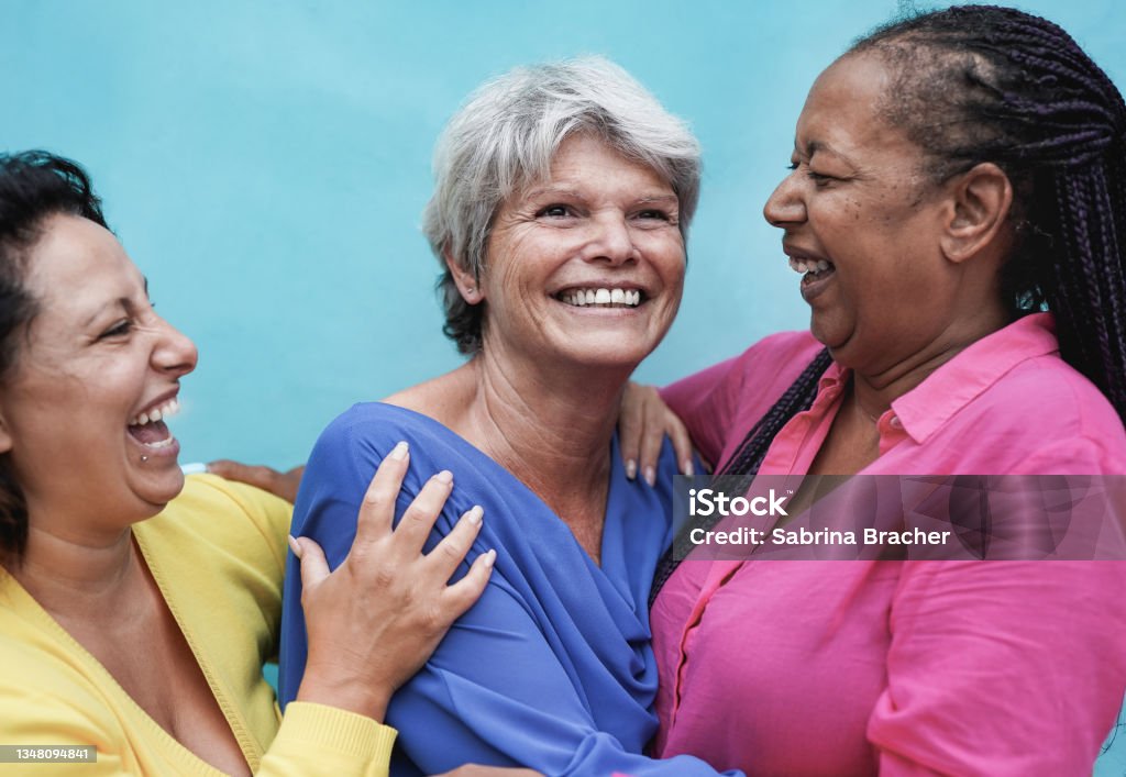 Mature Multiracial Women Having Fun Hugging Each Other In The City With