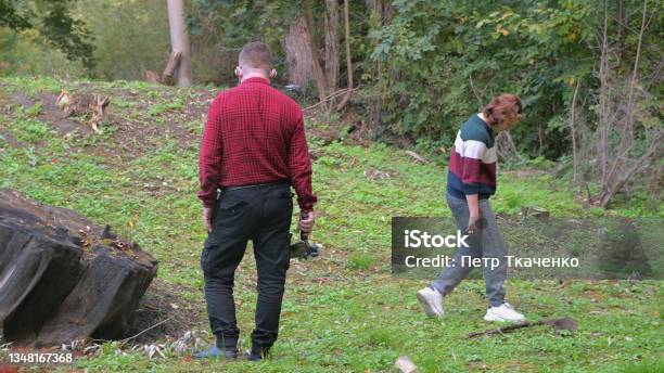 A Mans Dad And A Teenage Girls Daughter Walk Around The Clearing In