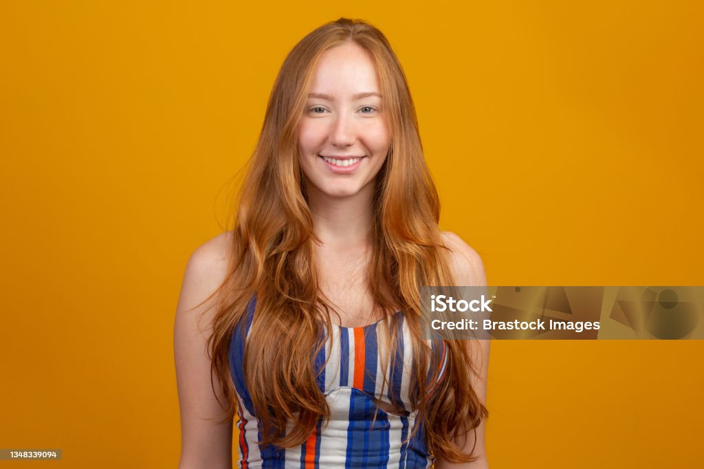 Portrait Of Beautiful Cheerful Redhead Girl With Flying Hair Smiling