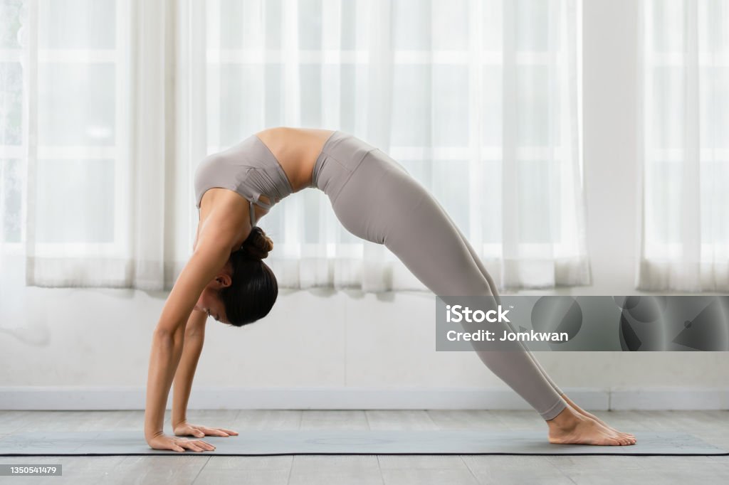 Wellness Attractive Asian Indian Woman Practice Yoga Bridge Pose To