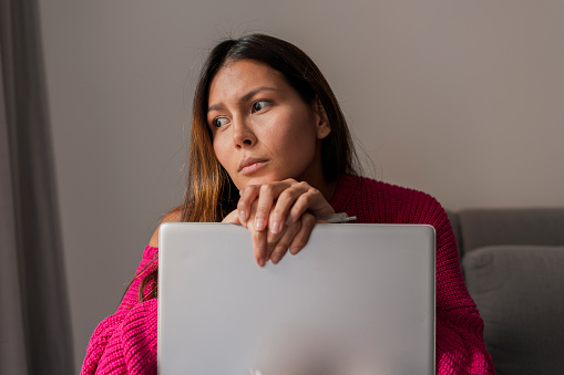 Woman Works At Home By Distancing Herself From The Sofa In Her Living ... Woman Works At Home By Distancing Herself From The Sofa In Her Living ...