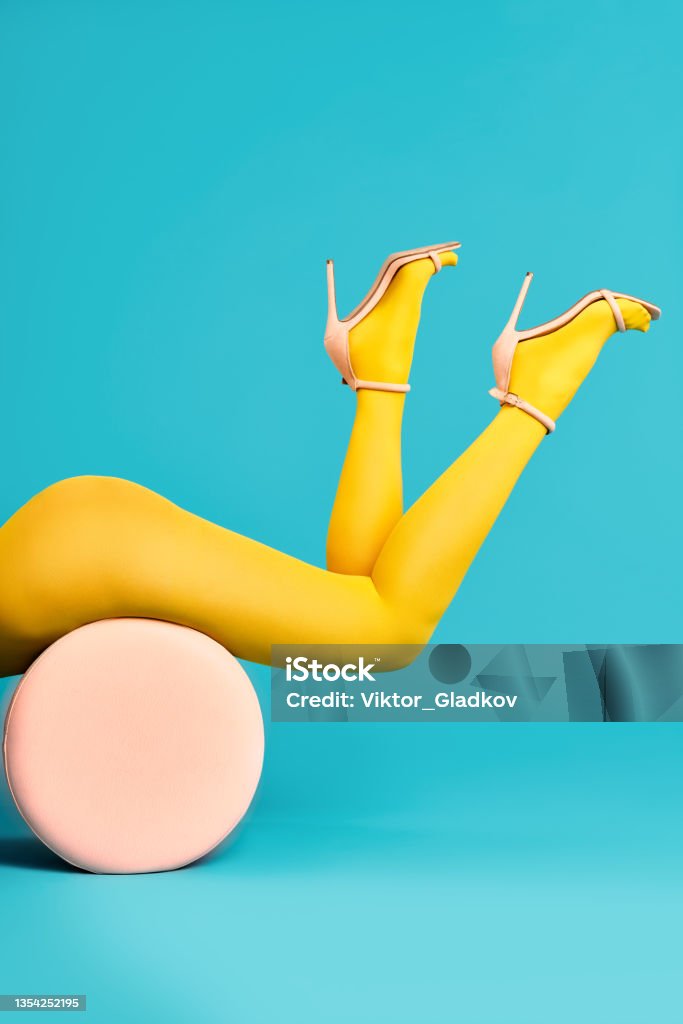 Legs Of Beautiful Young Woman Wearing Bright Yellow Tights And High