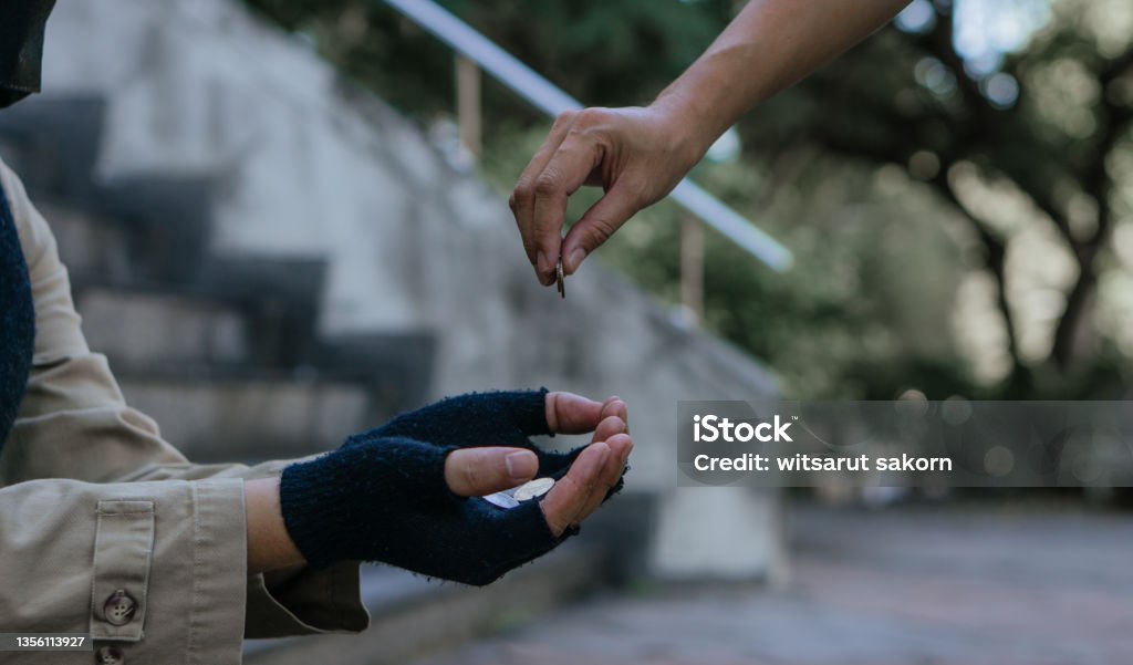Woman Giving Money To Homeless Beggar Man Sitting In Citygiving Concept