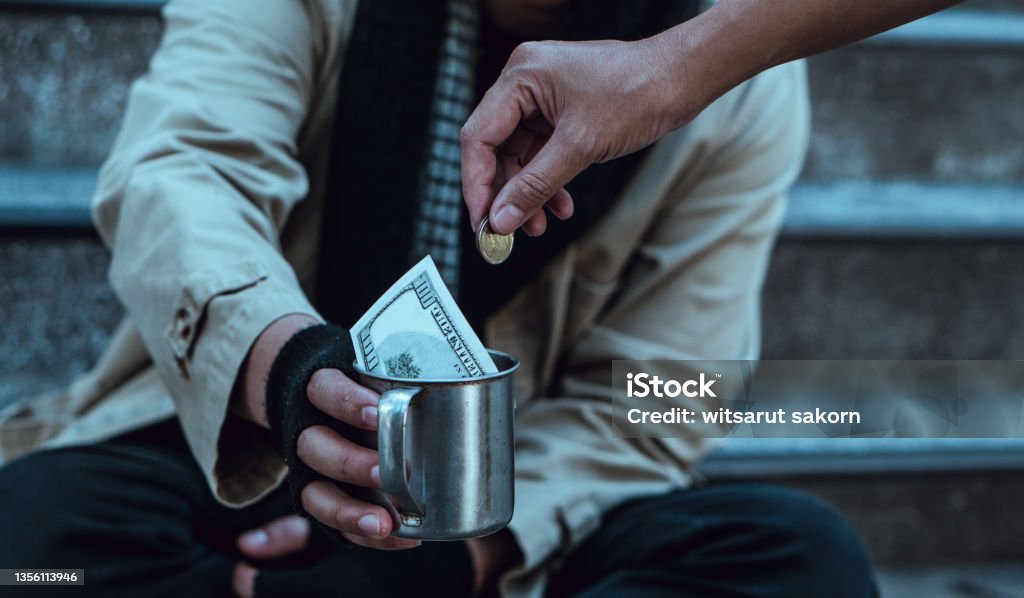 Woman Giving Money To Homeless Beggar Man Sitting In Citygiving Concept