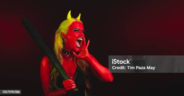 Red Demon Girl Whit Yellow Eyes And Yellow Horns And Hair Wearing Necklaces With Spikes On Dark