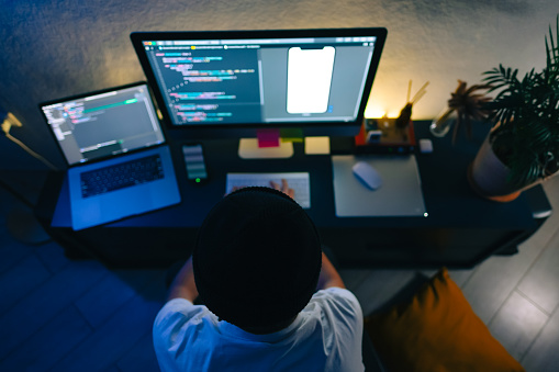 Young Man Mobile Developer Writes Program Code On A Computer Programmer