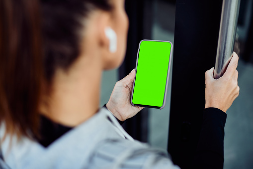 Closeup Of Athlete Using App On Mobile Phone While Entering In A Gym
