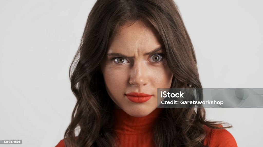 Portrait Of Attractive Girl Weirdly Looking In Camera Over White
