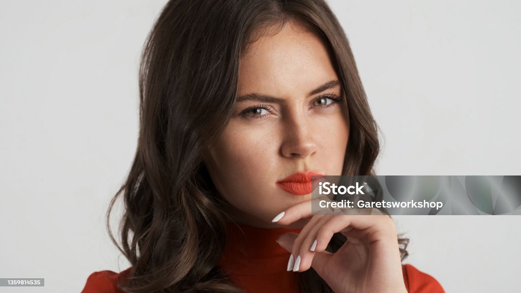 Portrait Of Attractive Tricky Girl Thoughtfully Looking In Camera Over