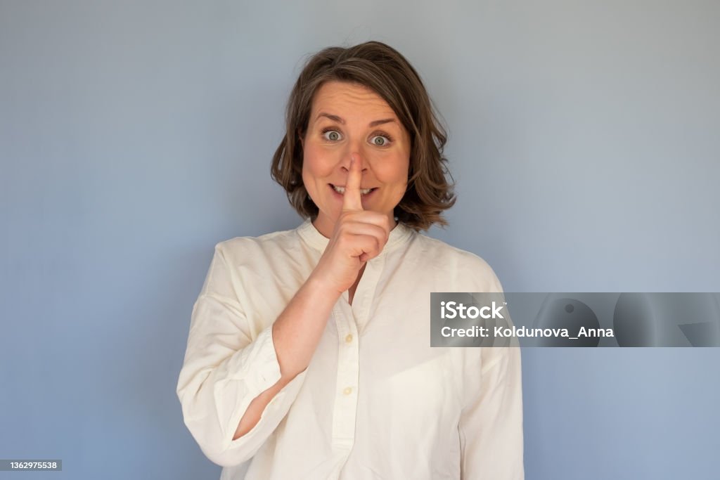 Secretive Young Woman Placing Finger On Lips Asking Shh Quiet Stock