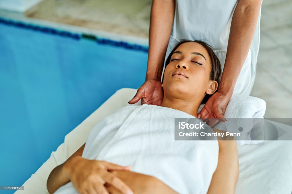 Shot Of An Attractive Young Woman Lying On A Bed And Enjoying A Massage