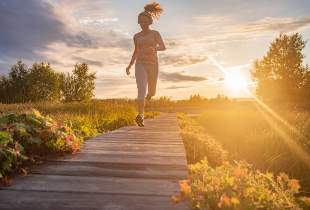Free Stock Photo of A young woman is running in nature outdoor at ...