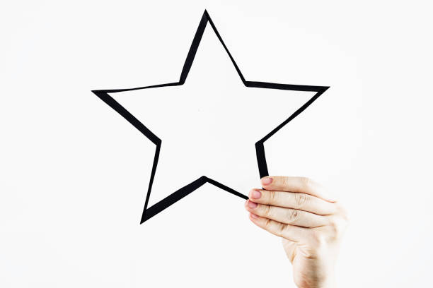 Free Stock Photo of A female hand holding a star shaped paper cut out ...