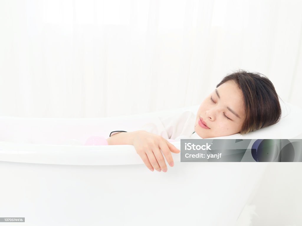 Portrait Of Young Asian Woman Lying In Bathtub Have A Good Dream