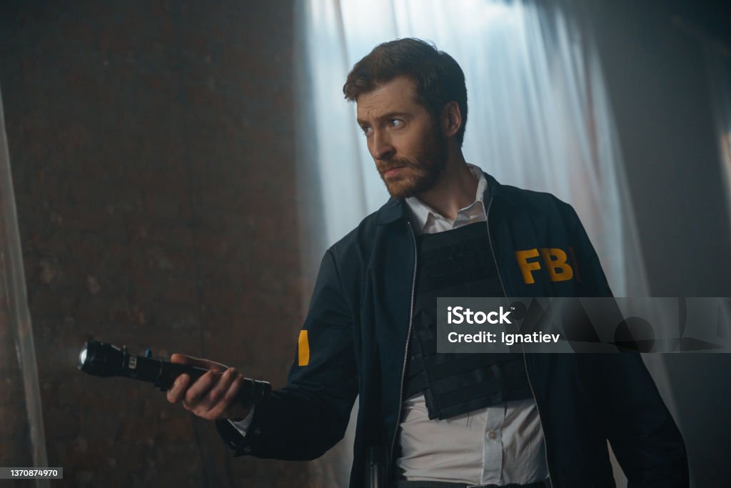 Handsome Fbi Agent With A Flash Light At The Crime Scene Standing In
