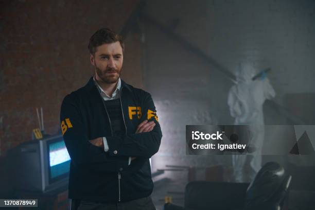 Handsome Fbi Agent Stands At The Crime Scene At The Den Of Criminals
