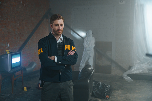 Handsome Fbi Agent With A Beard Stands At The Crime Scene At The Den Of