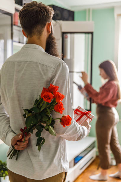 Free Stock Photo of A young man giving red rose to a young woman ...