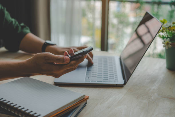 Free Stock Photo of View of a hand typing on laptop and using a phone ...