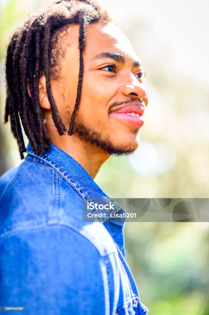 Handsome Young Black Man With Dreads Smiles In A Candid Headshot