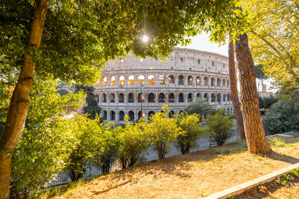 Free Stock Photo of Ancient Colosseum surrounded by lush trees in Rome ...