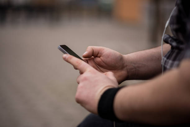 Free Stock Photo of Hand holding smartphone capturing tall urban ...