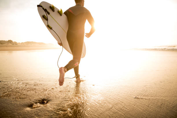 Free Stock Photo of Man running into the sea with a surfboard ...