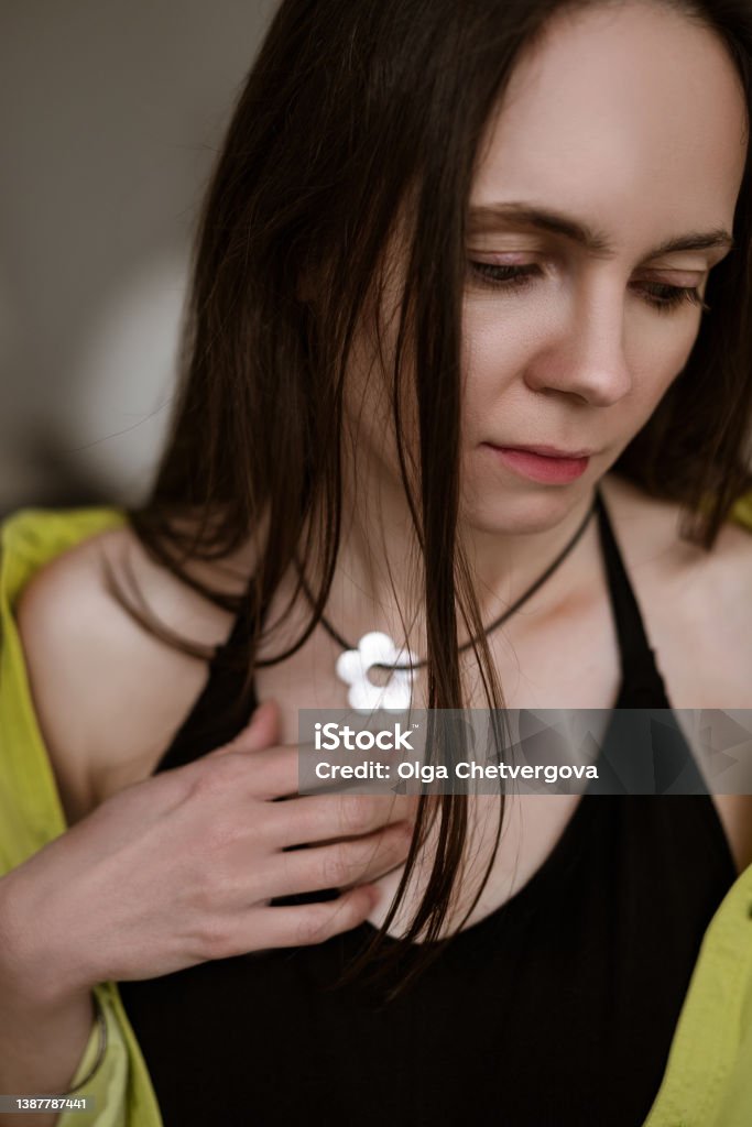 Portrait Of Attractive Young Brunette Woman With Long Dark Hair Holding