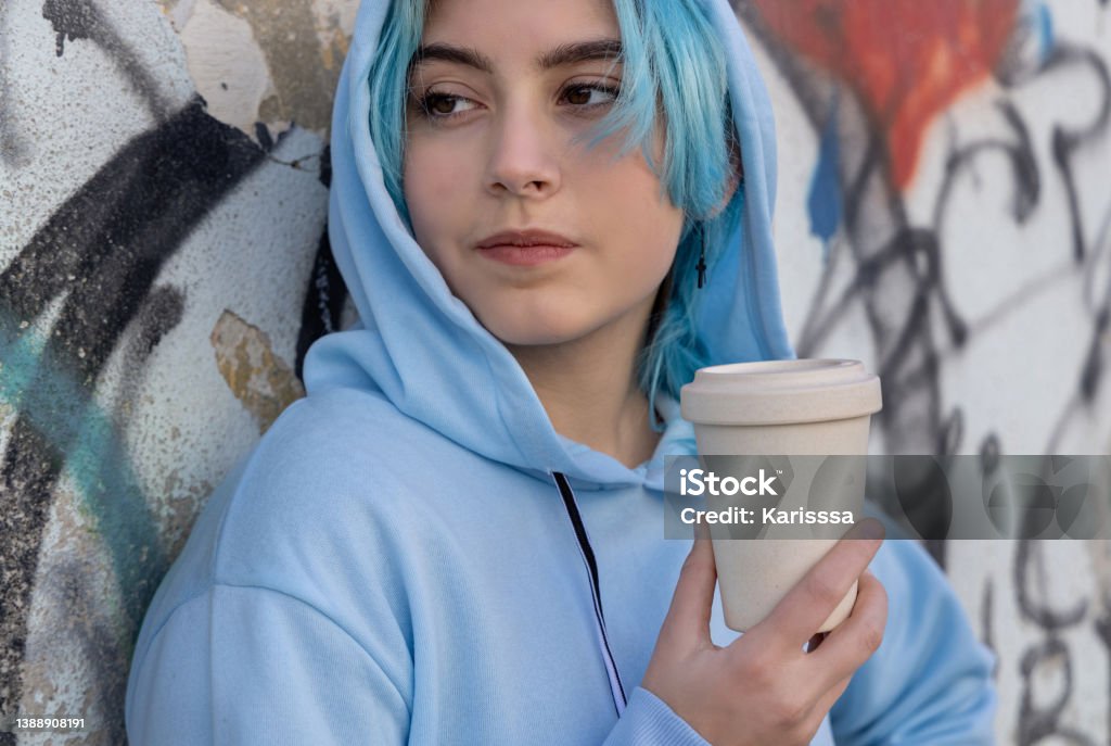 Blue Haired Teenage Girl In Light Blue Oversize Hoodie Staying Near