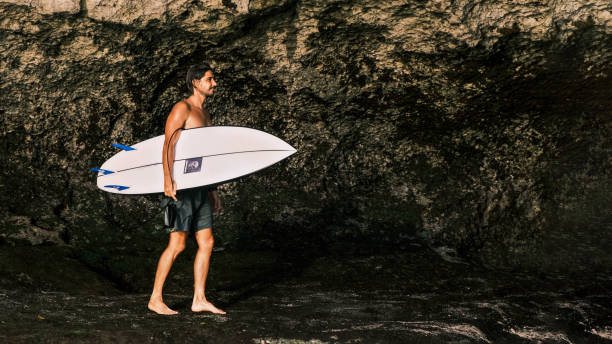 Free Stock Photo of Man Standing on Rock With Surfboard | Download Free ...