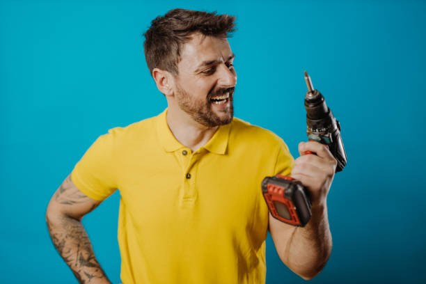 Free Stock Photo of Smiling Man Holding Drill and Hammer | Download ...