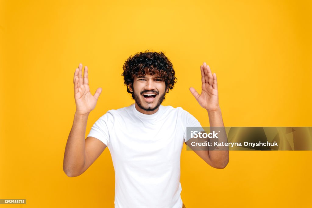 Confused Puzzled Indian Or Arabian Attractive Curlyhaired Young Man