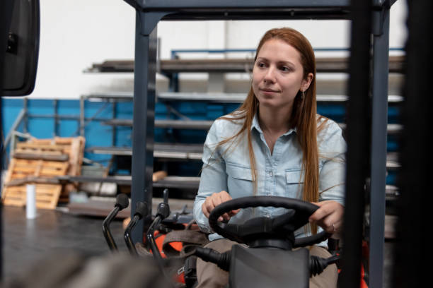 Free Stock Photo of Caucasian female warehouse worker driving forklift ...