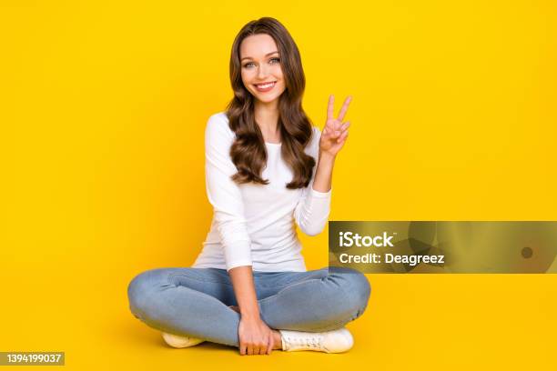 Photo Of Peaceful Adorable Woman Wear White Shirt Showing Vsign Sitting