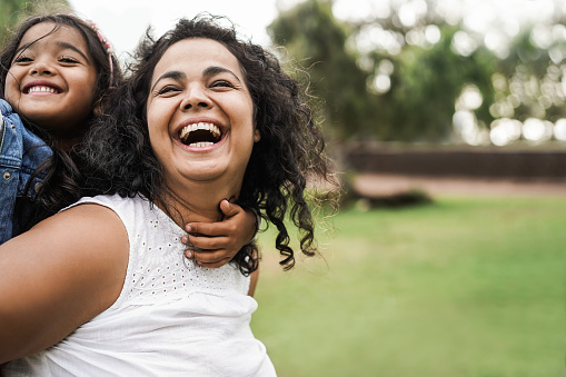 Happy Indian Mother Having Fun With Her Daughter Outdoor Focus On Mom