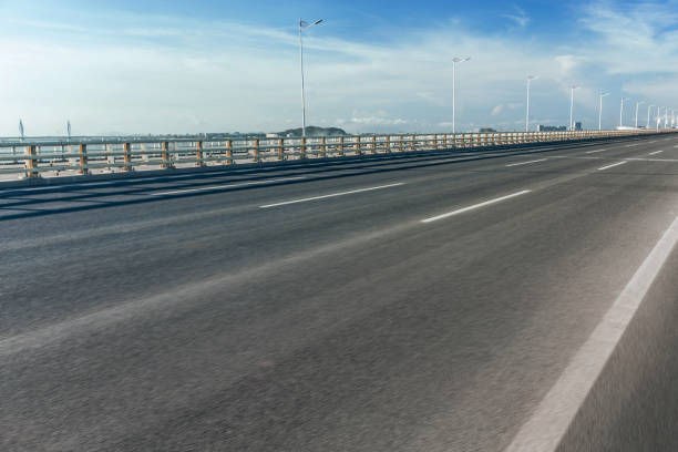 Free Stock Photo of Car Driving on Road With Bridge in Background ...
