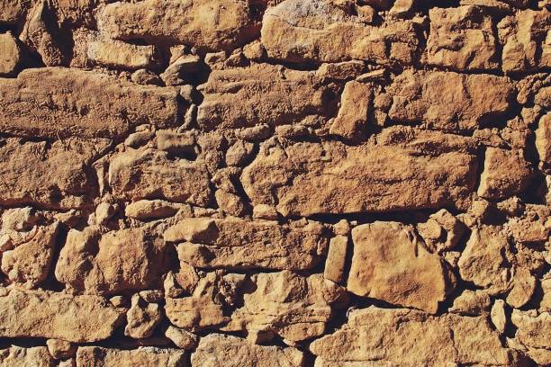 Close-up of a weathered rock wall with a rough, textured surface | Free ...