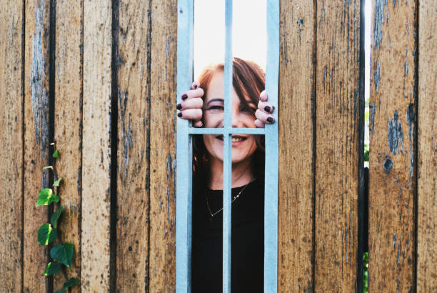 Free Stock Photo of Woman looking out through barred window | Download ...