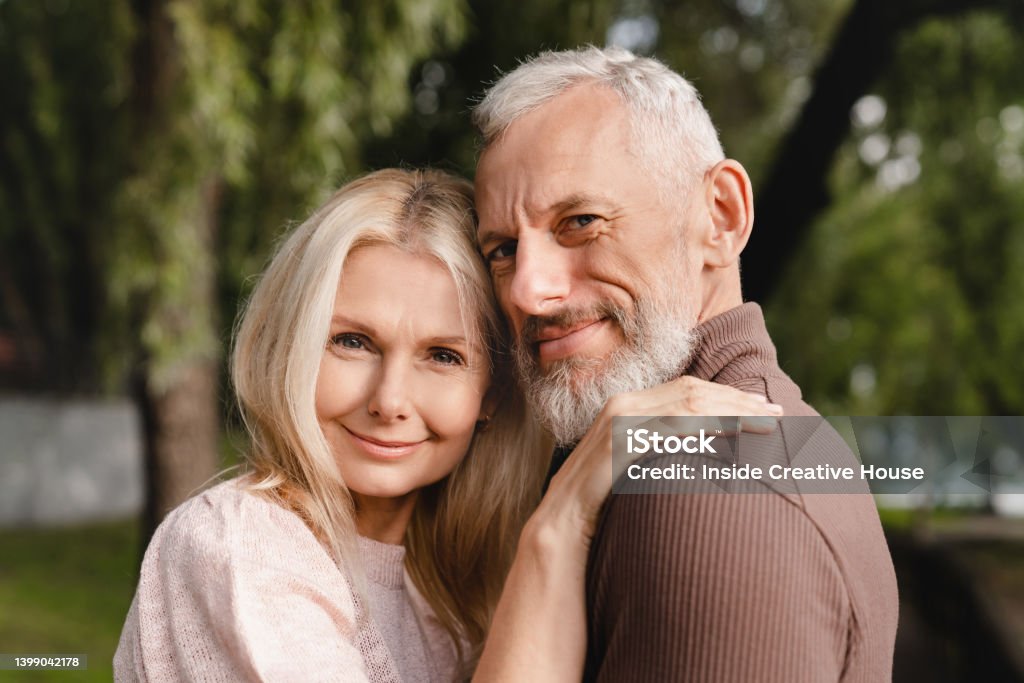 Confident Happy Cheerful Mature Couple Embracing Hugging Each Other