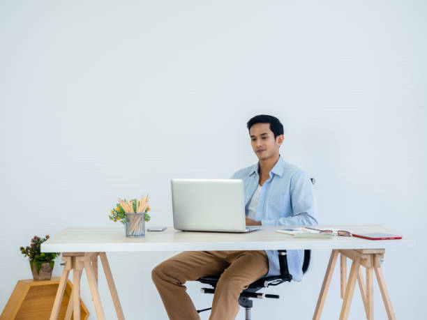 Free Stock Photo of Man Sitting at Table Using Laptop Computer ...